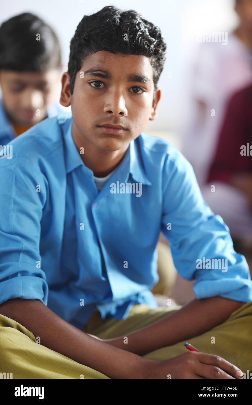 Boy sitting in a classroom Stock Photo - Alamy