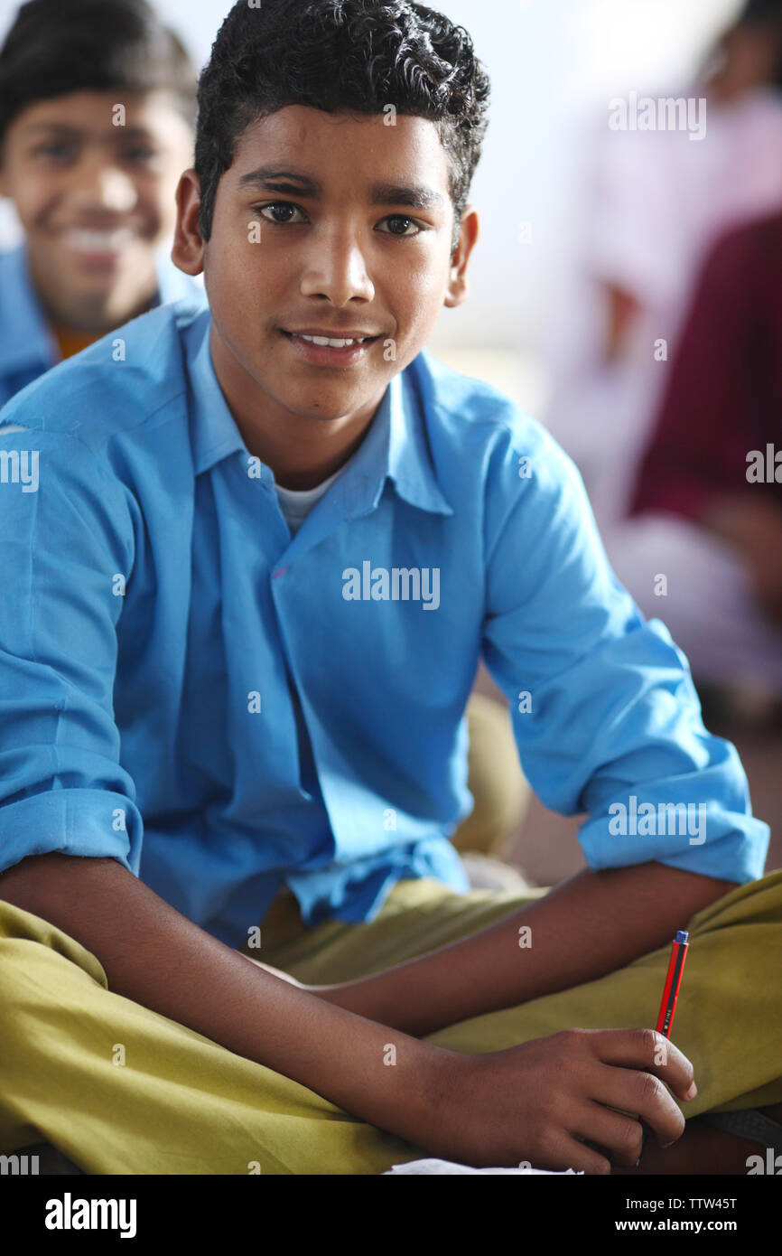 Boy reading in a classroom Stock Photo - Alamy