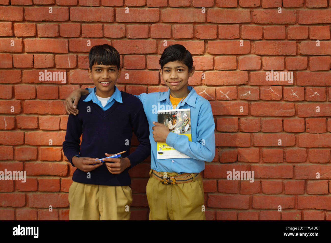 Two schoolboys standing together Stock Photo - Alamy