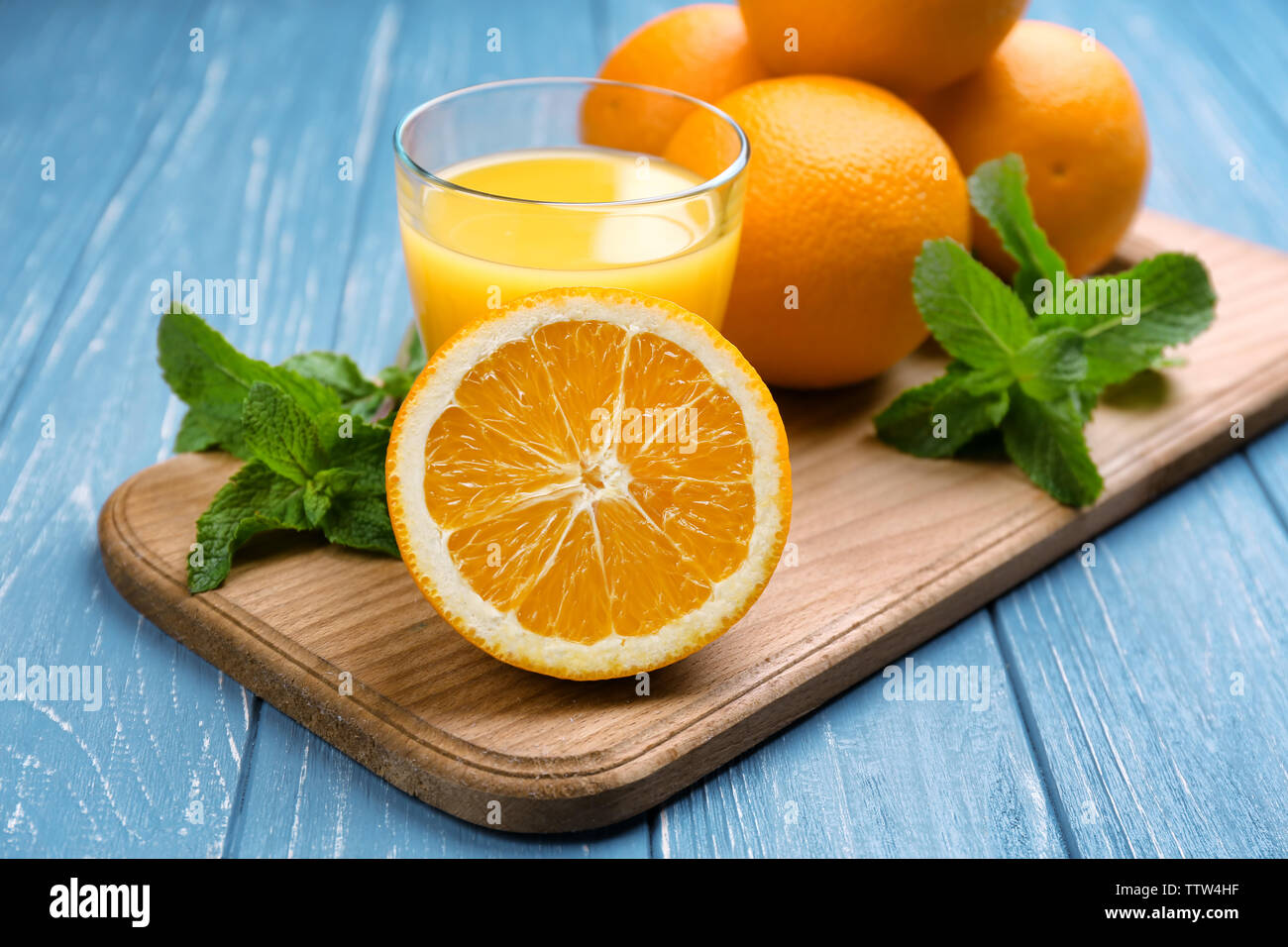 Fresh orange juice with fruits on cutting board Stock Photo - Alamy