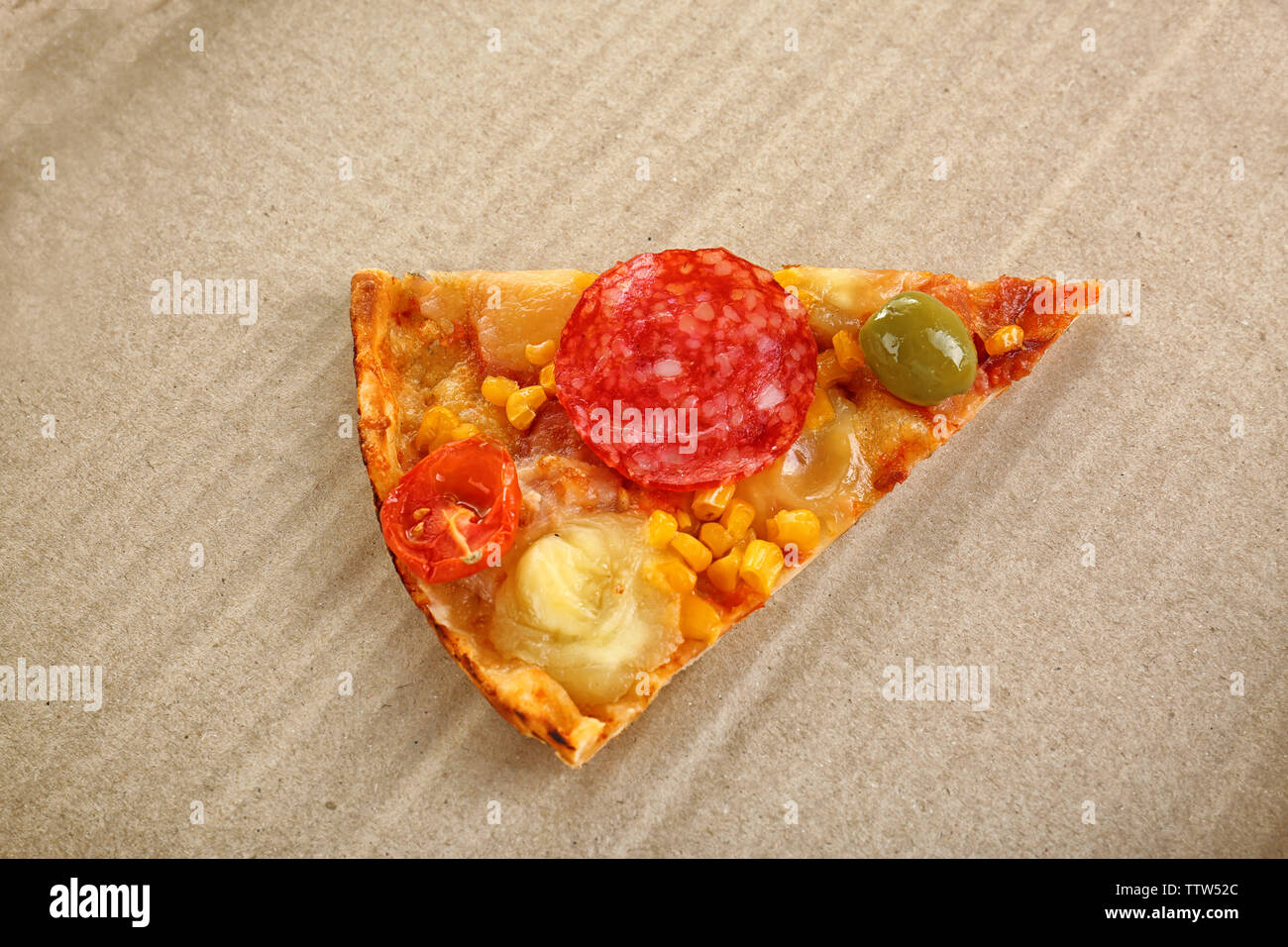 Tasty pizza slice on cardboard Stock Photo - Alamy