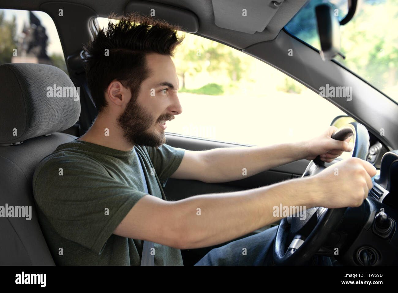 Portrait of handsome young man driving car Stock Photo - Alamy