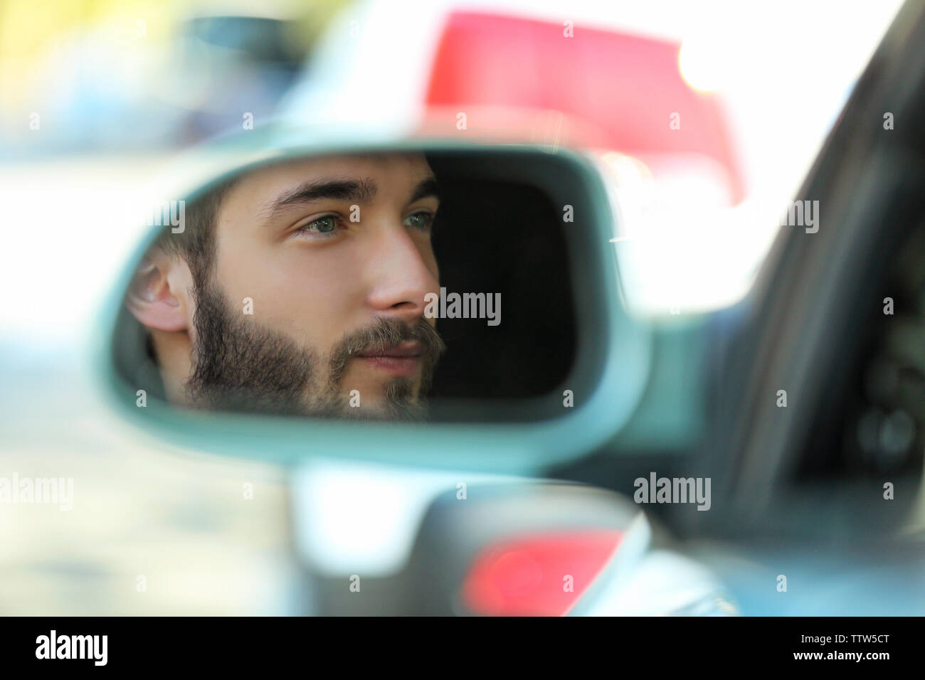 Reflection of successful young man in car side mirror Stock Photo - Alamy