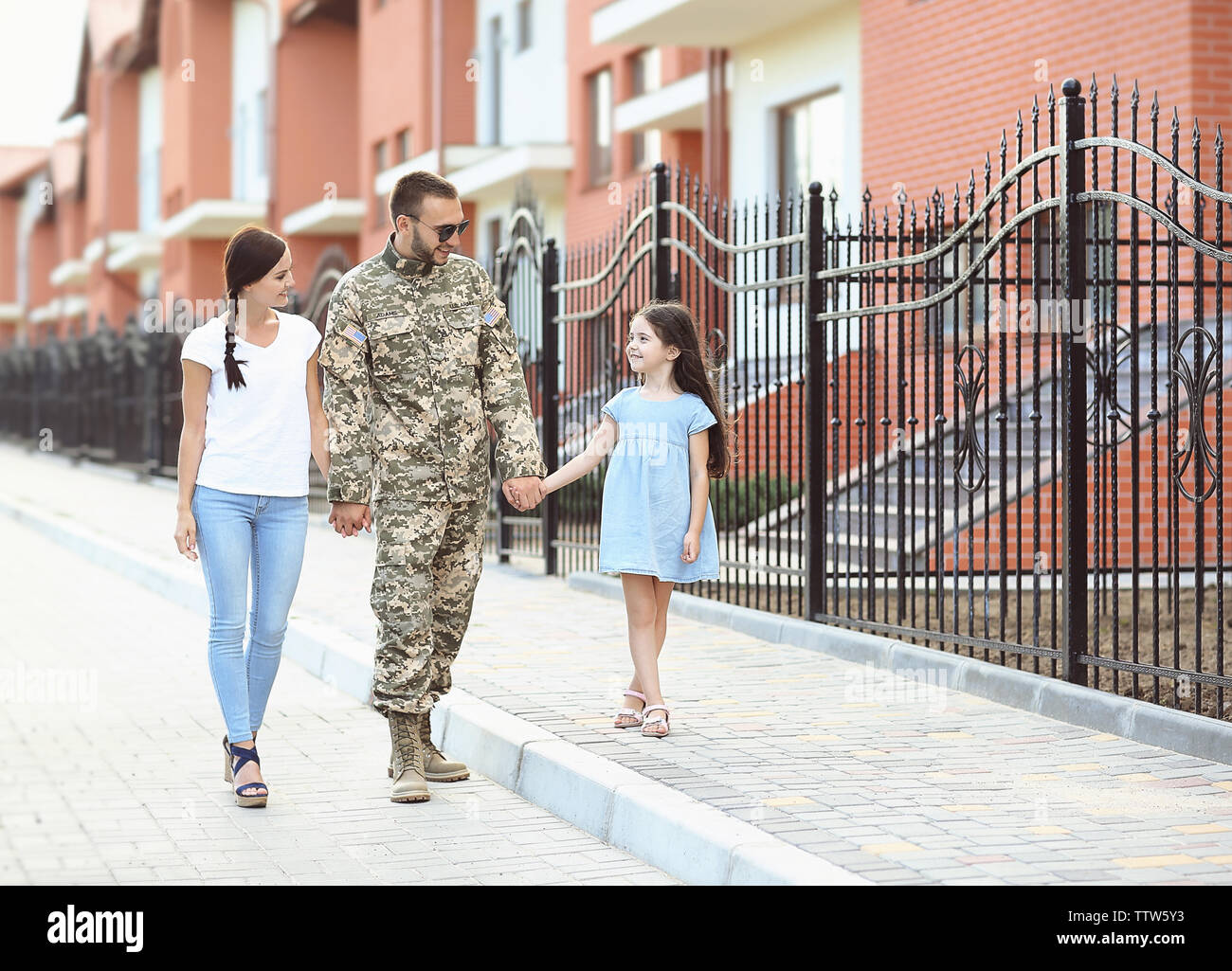 US army soldier with family on street Stock Photo - Alamy