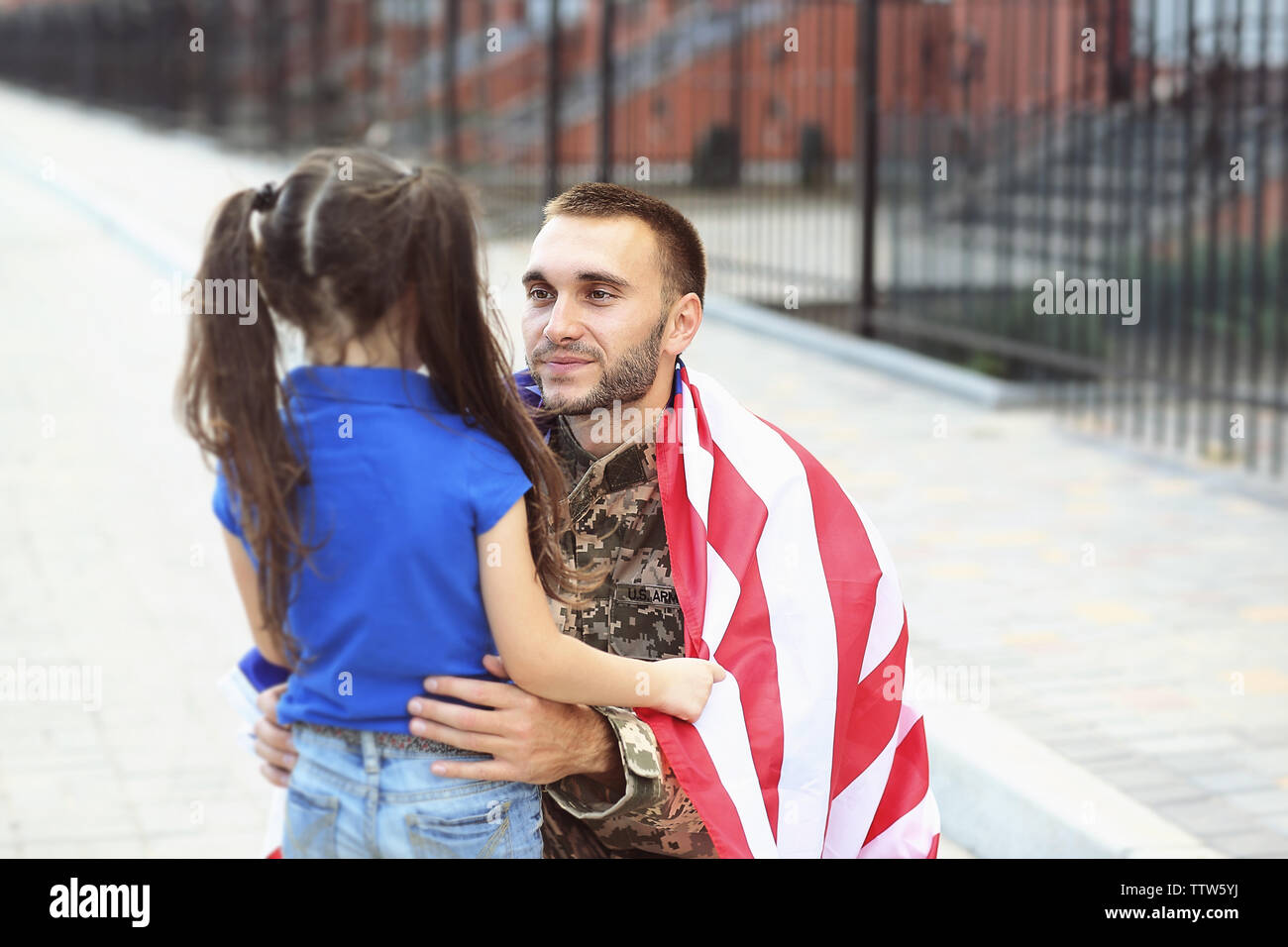 Happy reunion of US army soldier with daughter Stock Photo - Alamy
