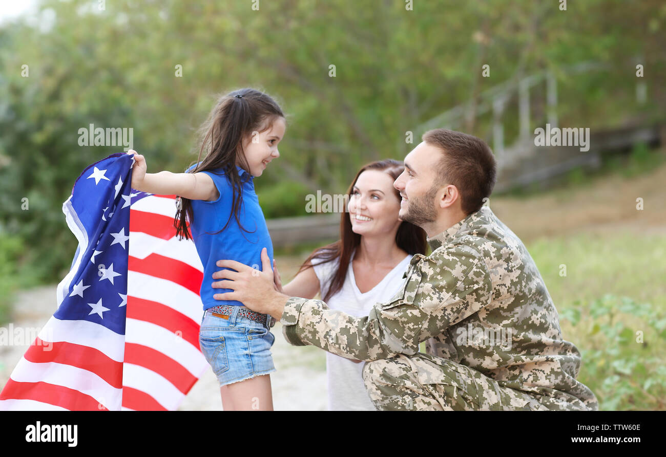 US army soldier with family and USA flag in park Stock Photo - Alamy