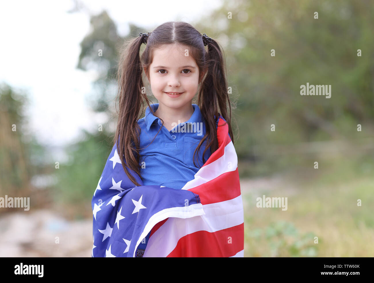 Cute little girl with USA flag in park Stock Photo - Alamy