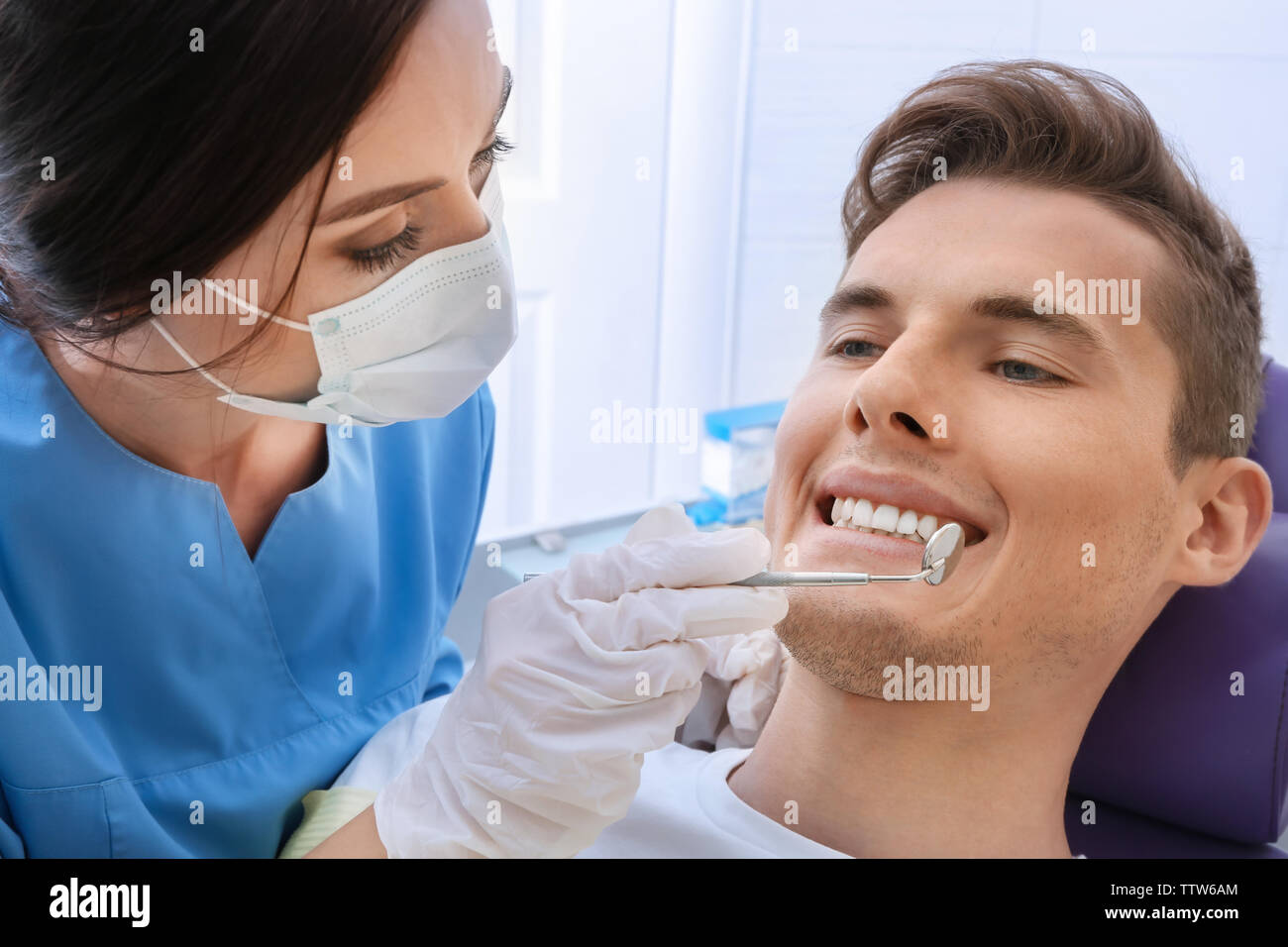 Dentist examining patient teeth in clinic Stock Photo - Alamy