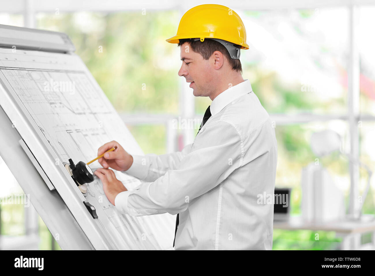 Young creative male engineer making project on drawing board Stock ...