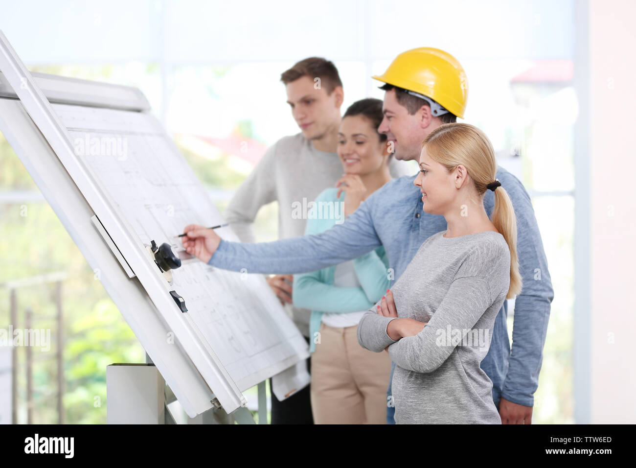 Team of young creative engineers working with new architectural project ...