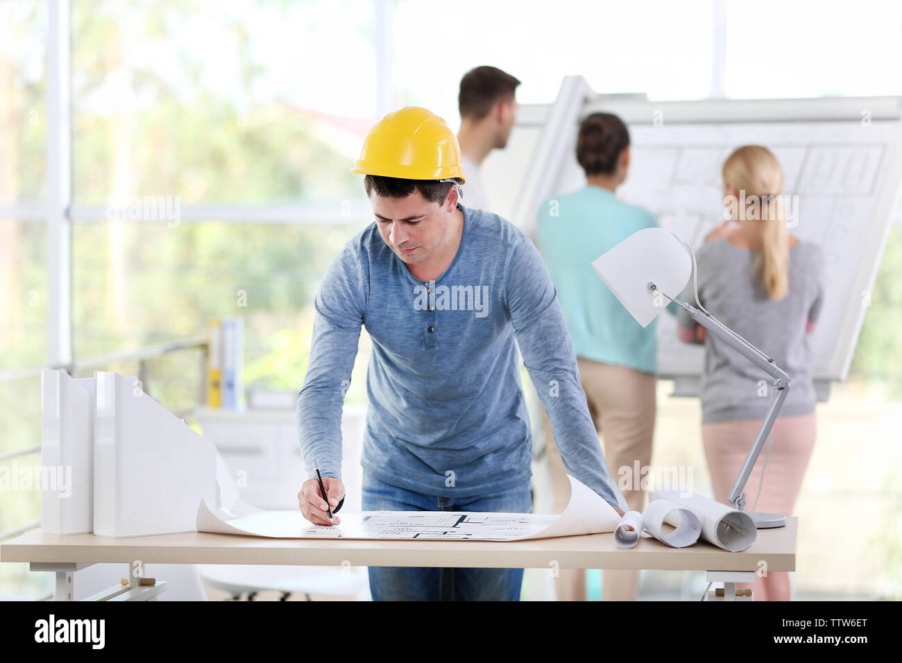 Young engineers planning project in office Stock Photo - Alamy