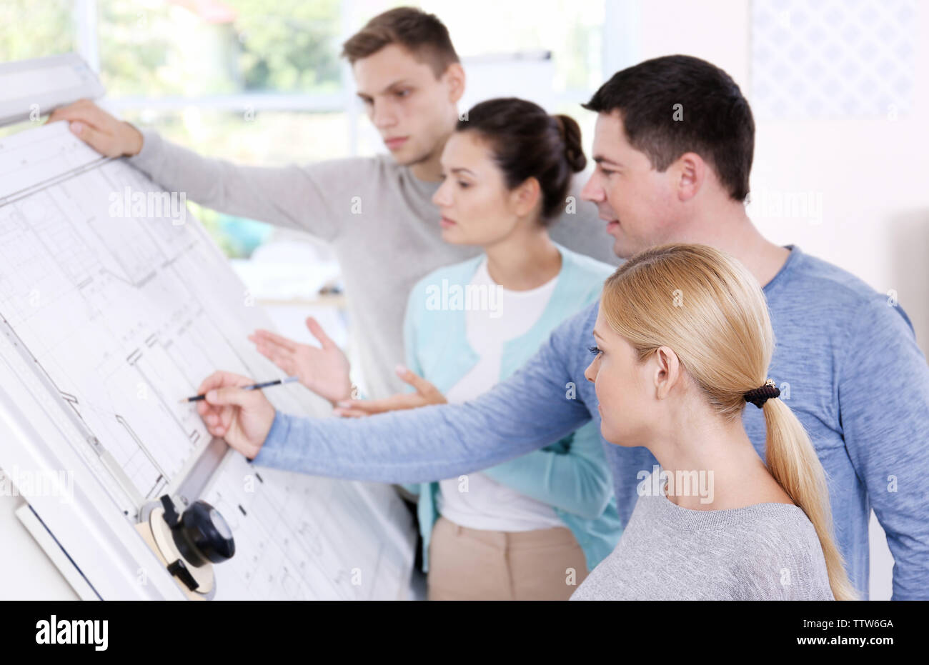 Team of young creative engineers working with new architectural project ...