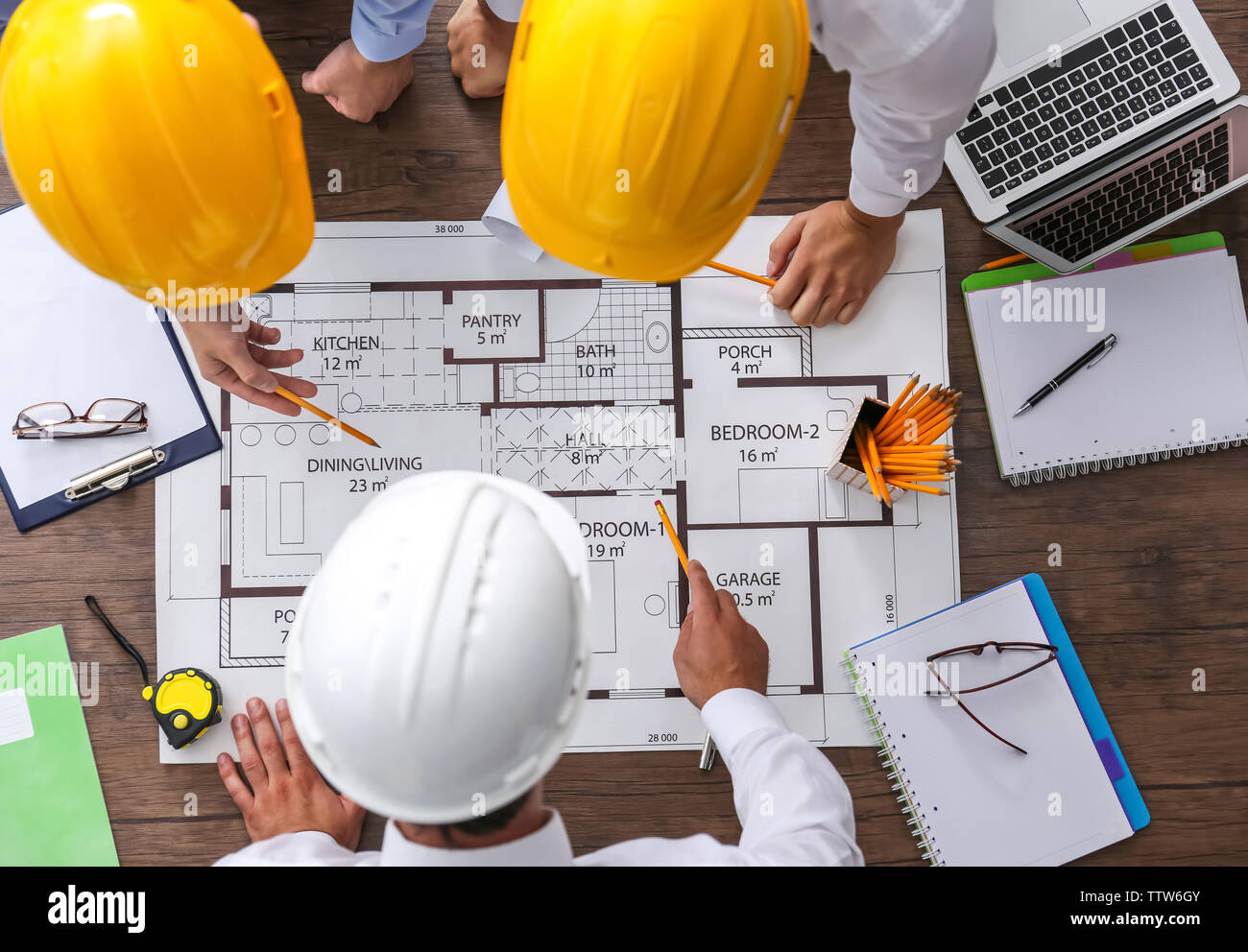Engineers in helmets planning new project on table, top view Stock ...