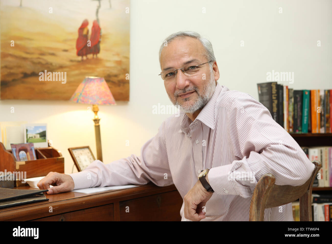 Portrait of an old man sitting at a table Stock Photo - Alamy