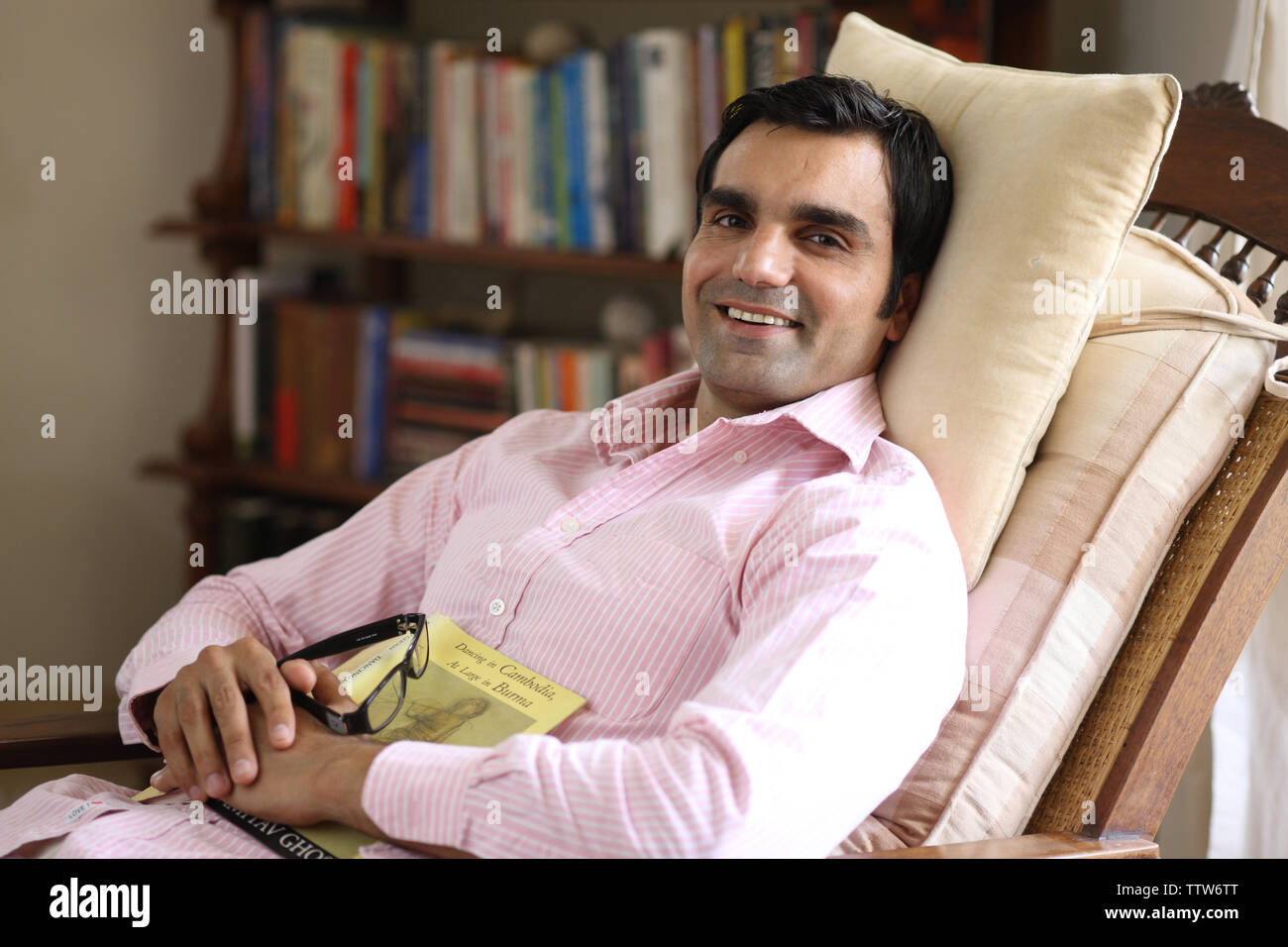 Man reclining on chair and smiling Stock Photo - Alamy