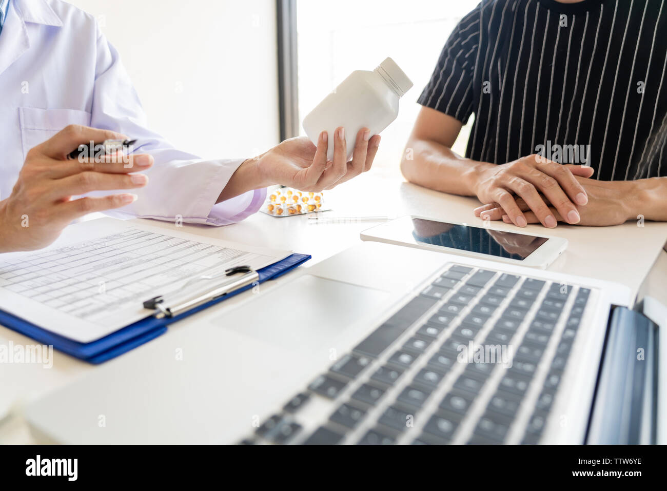 health care concept, doctor give a medicine bottle of drugs pills and ...