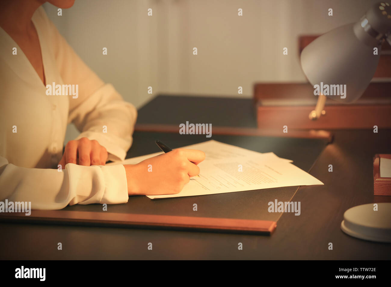 Woman signing important documents in modern office Stock Photo - Alamy