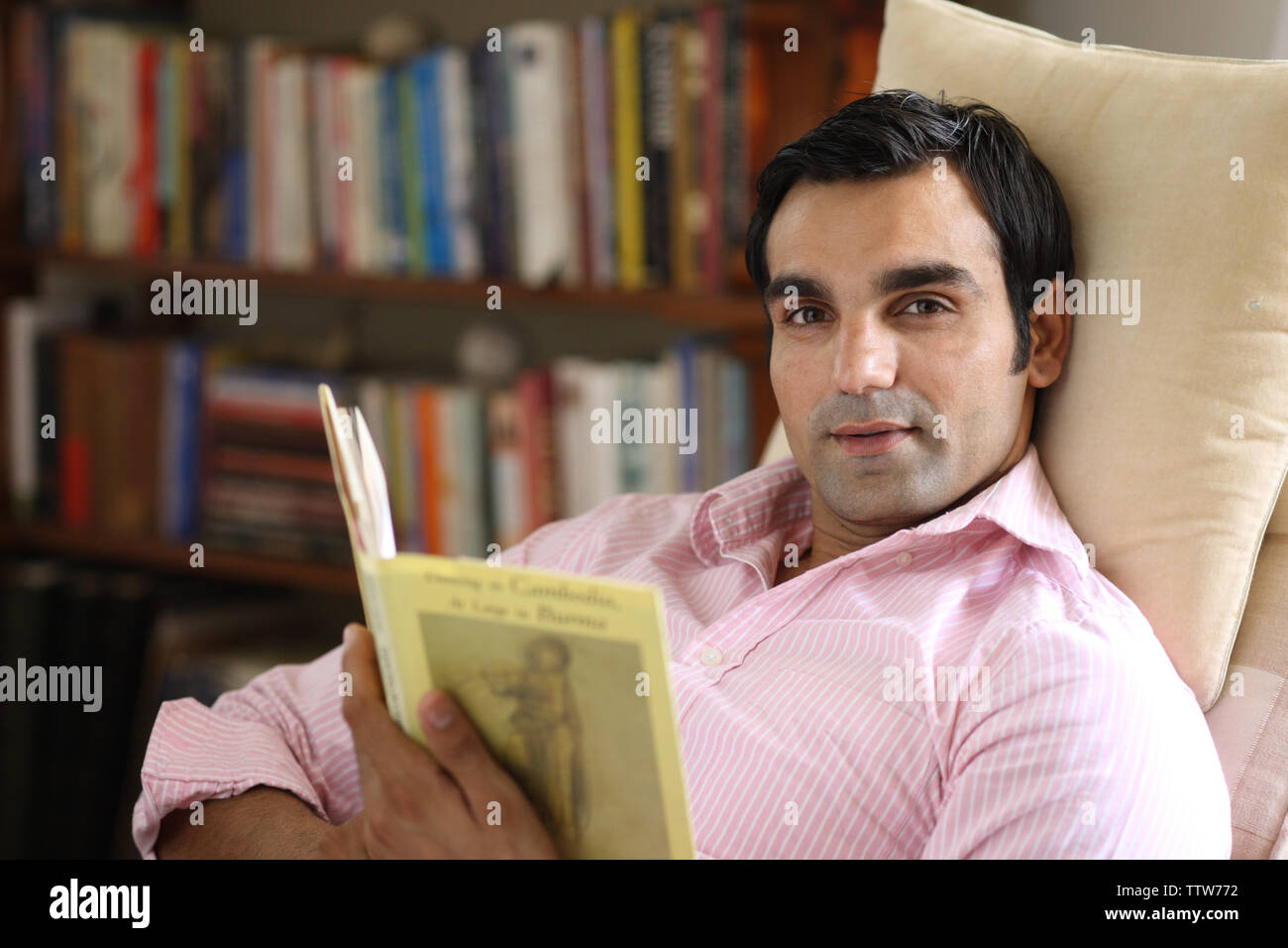 Indian man book reading reclining hi-res stock photography and images ...