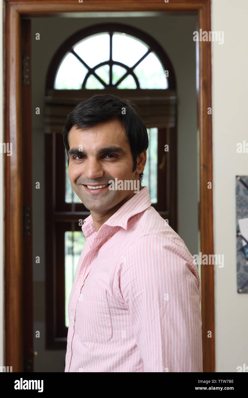 Portrait of an Indian young man smiling Stock Photo - Alamy