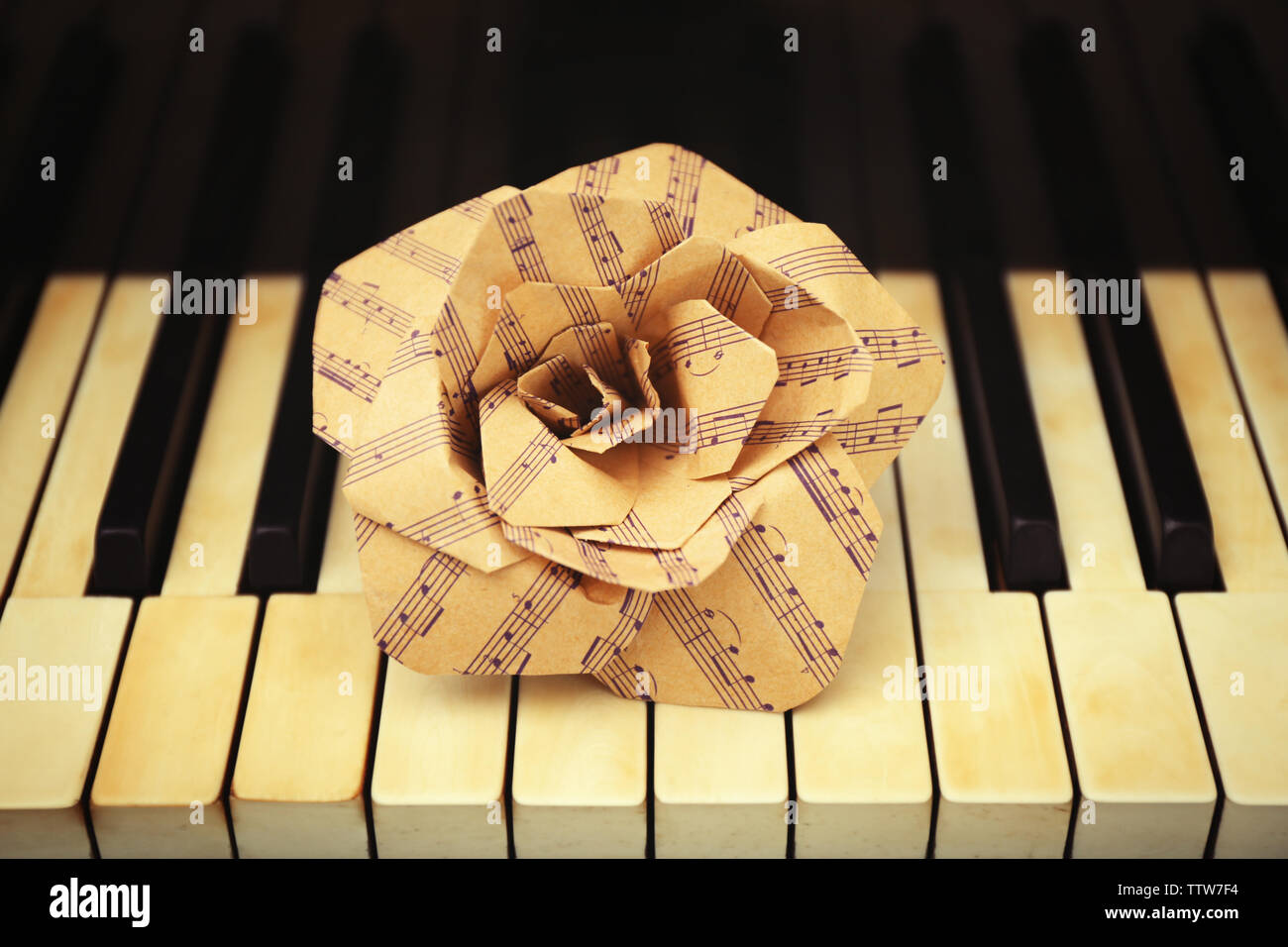 Rose made of music notes on piano keys Stock Photo - Alamy