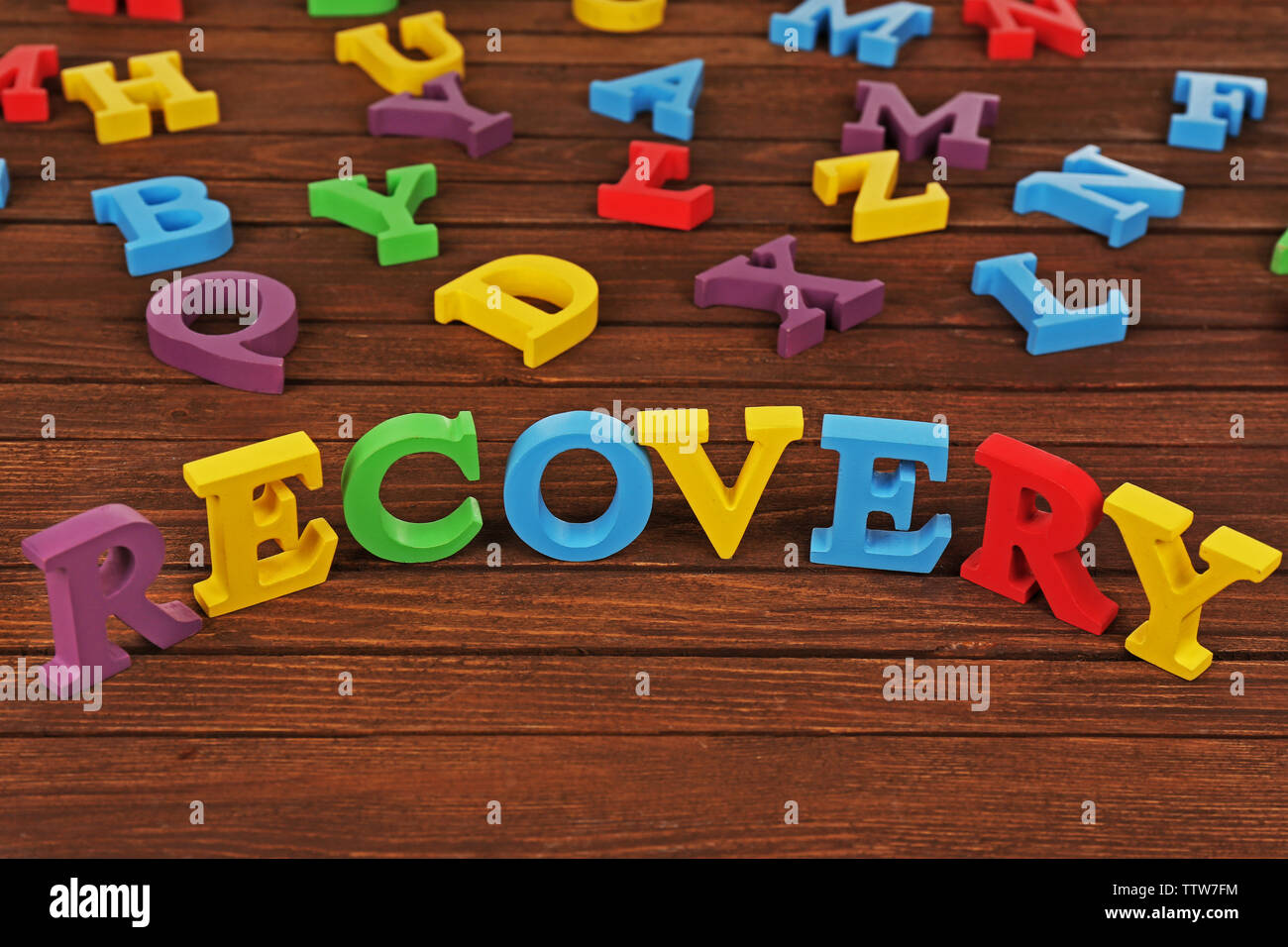 Word RECOVERY made of colourful letters on wooden background Stock ...