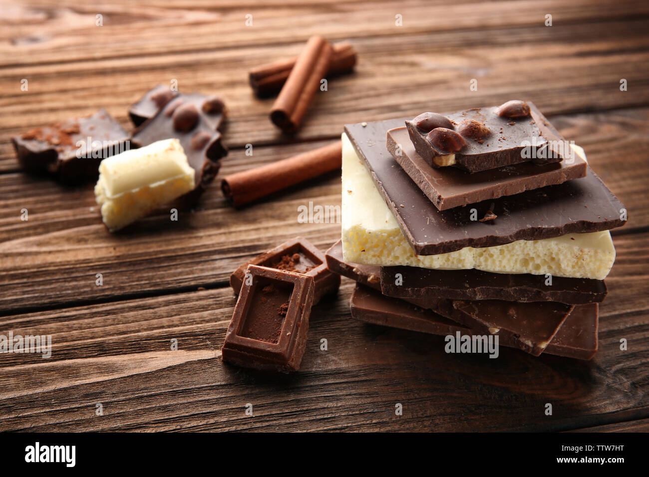 Broken chocolate pieces with cinnamon on table Stock Photo - Alamy