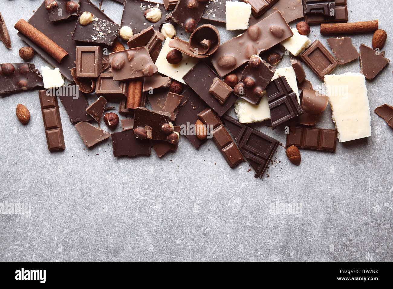 Heap of broken chocolate pieces on table Stock Photo - Alamy