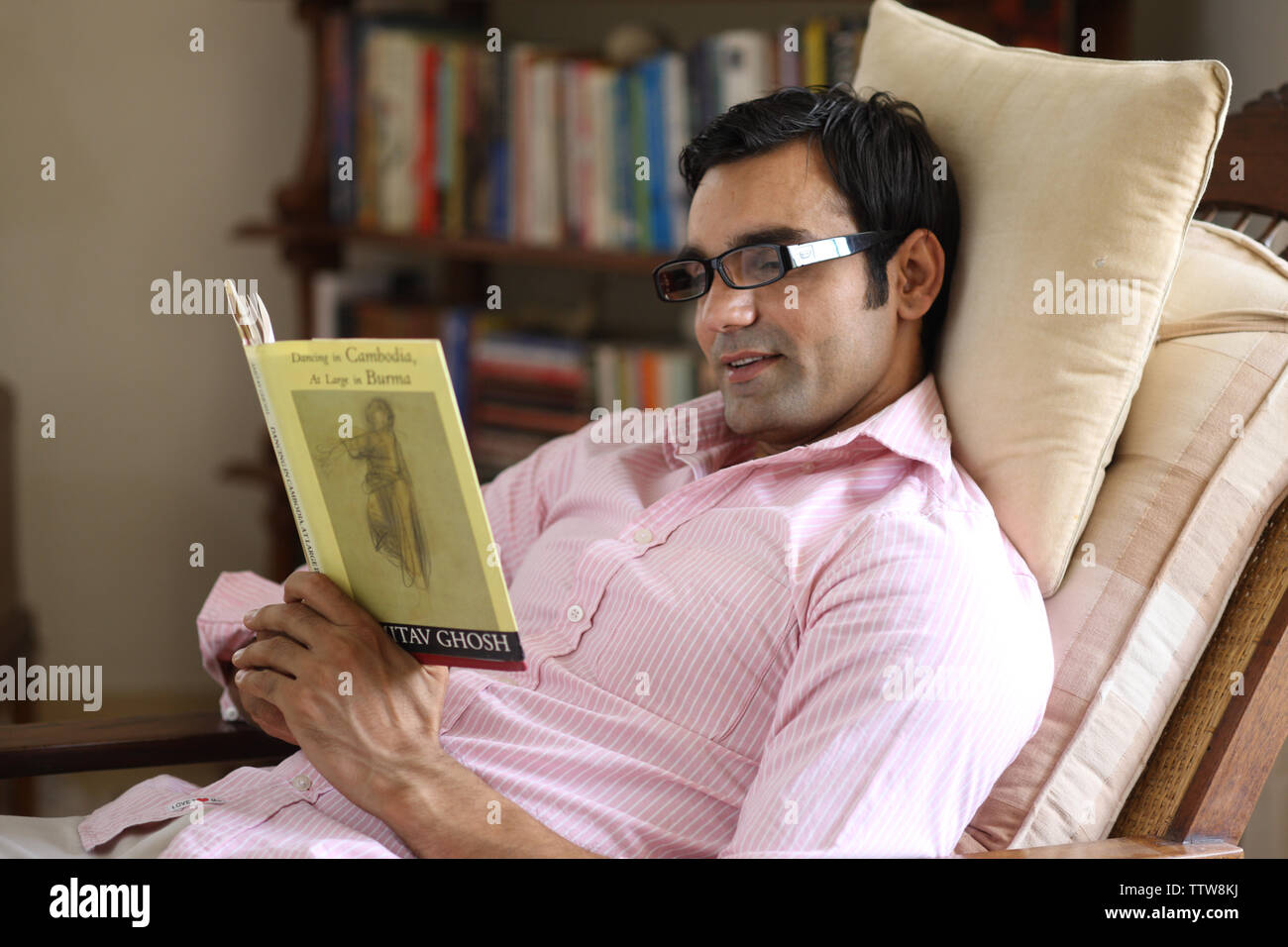 Indian man book reading reclining hi-res stock photography and images ...