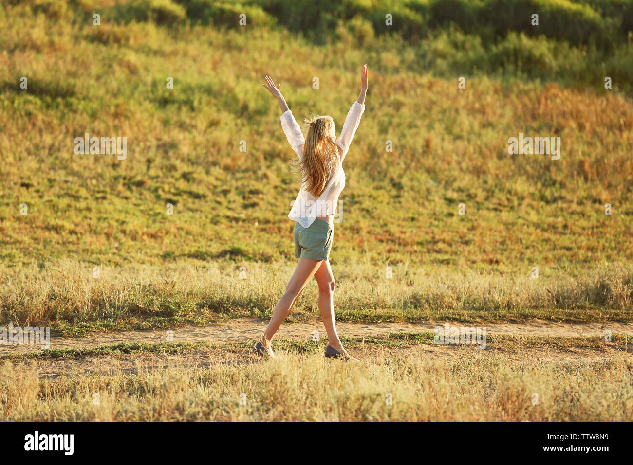 Young woman walking on field hi-res stock photography and images - Alamy