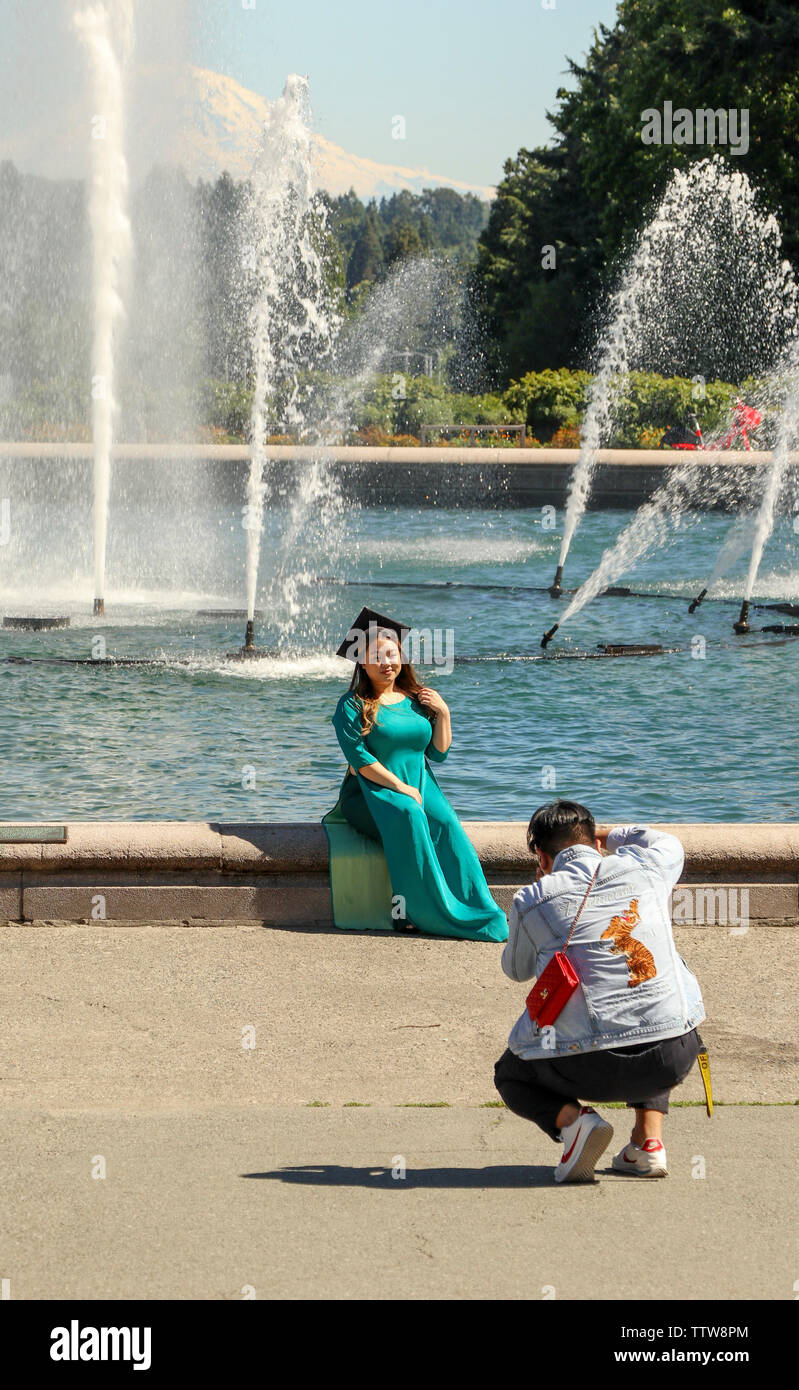 Asian family taking graduation photos at Drumheller Fountain ...