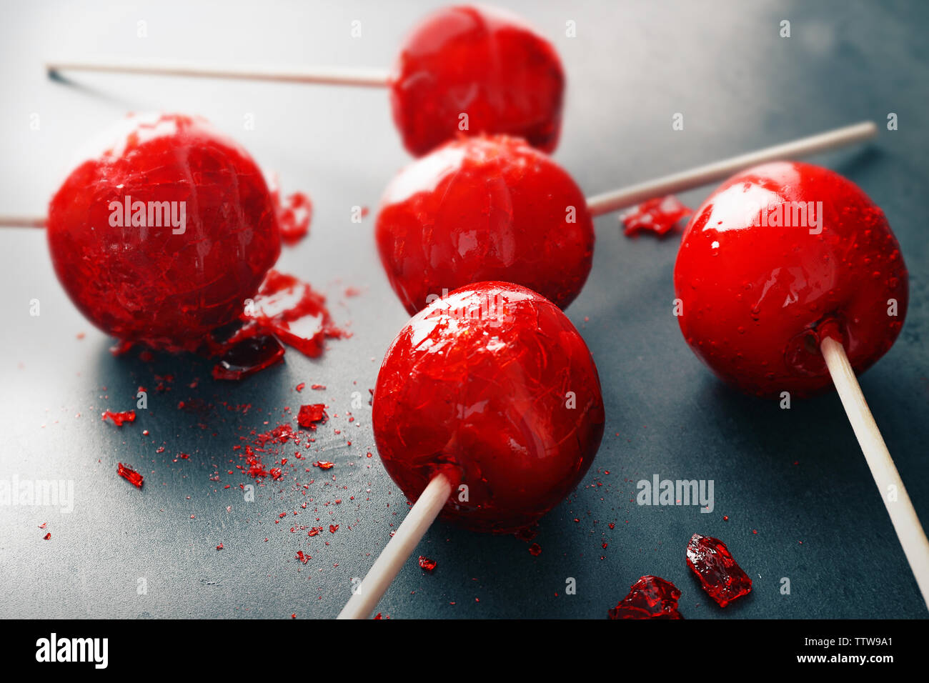 Toffee apples on grey background Stock Photo - Alamy