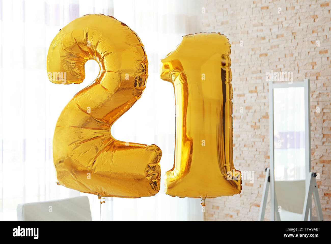 Golden balloons for 21st birthday celebration Stock Photo - Alamy