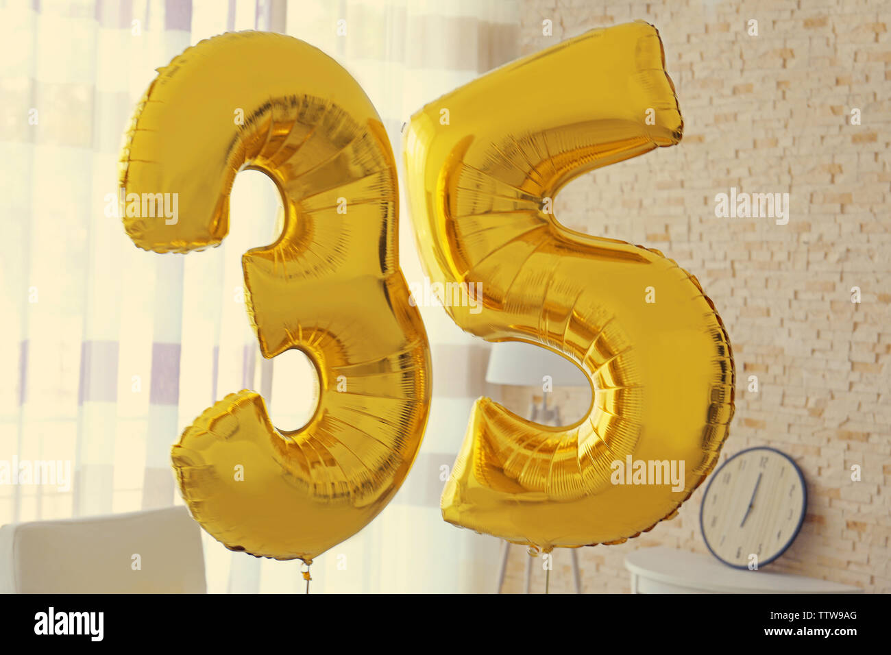 Golden balloons for 35th birthday celebration Stock Photo - Alamy