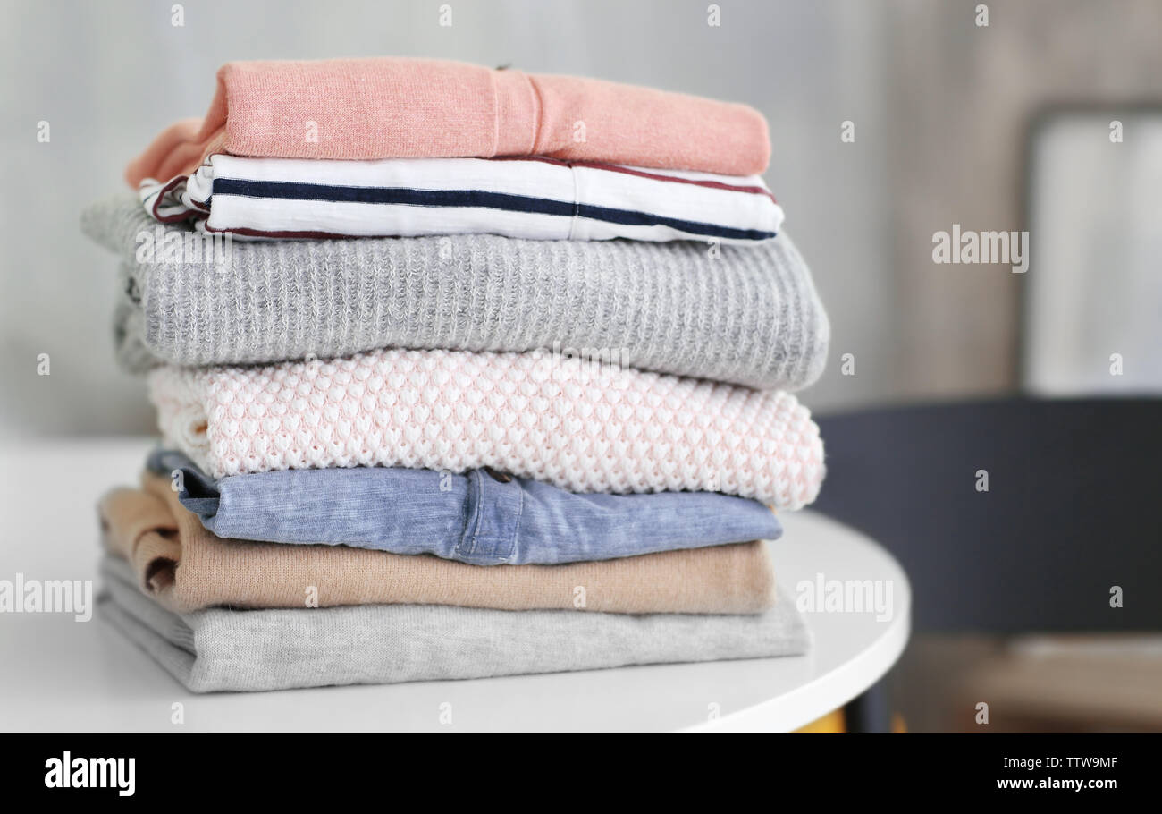 Pile of clothes on table Stock Photo - Alamy