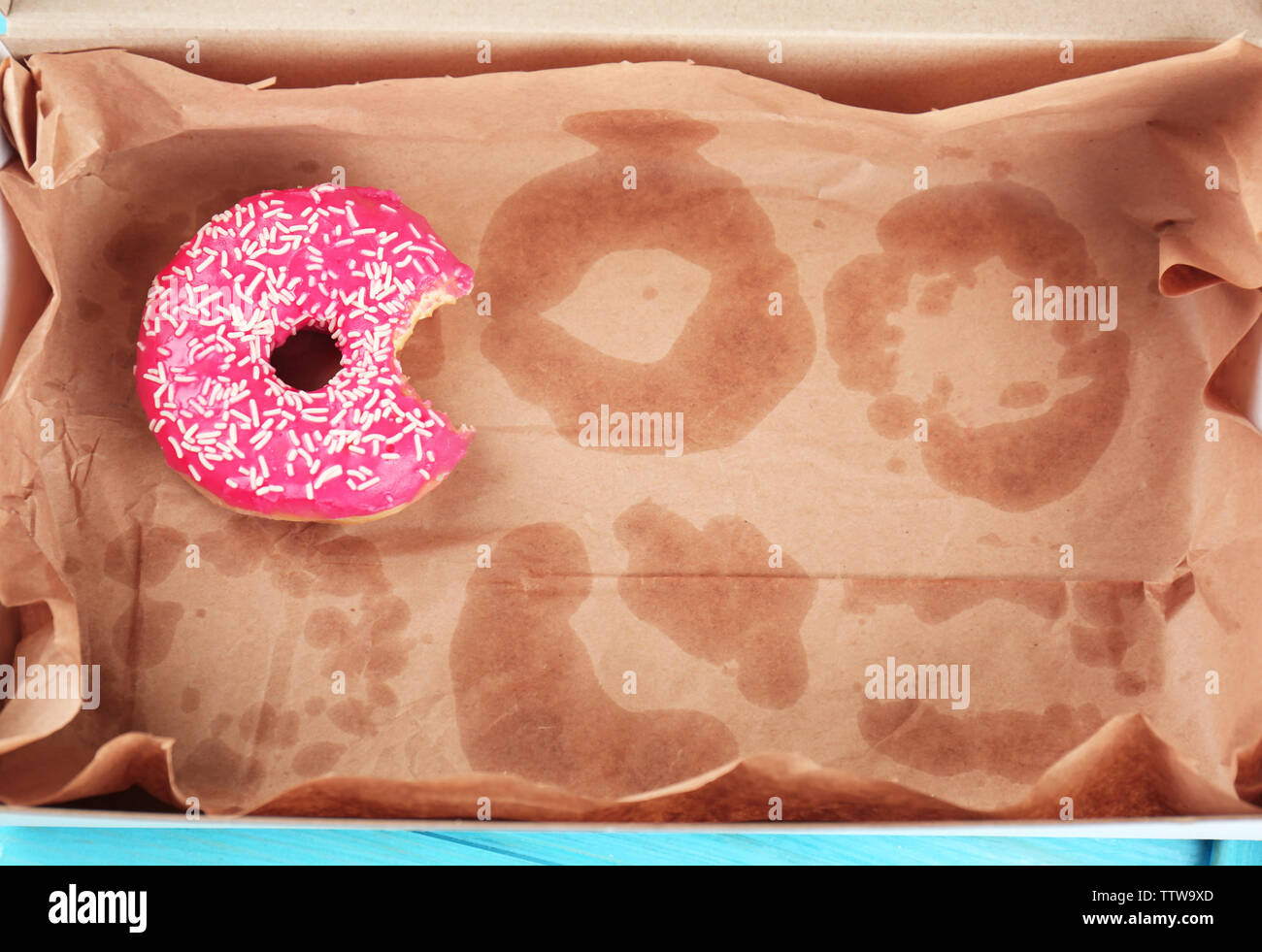 Delicious donut on greasy paper in box Stock Photo - Alamy