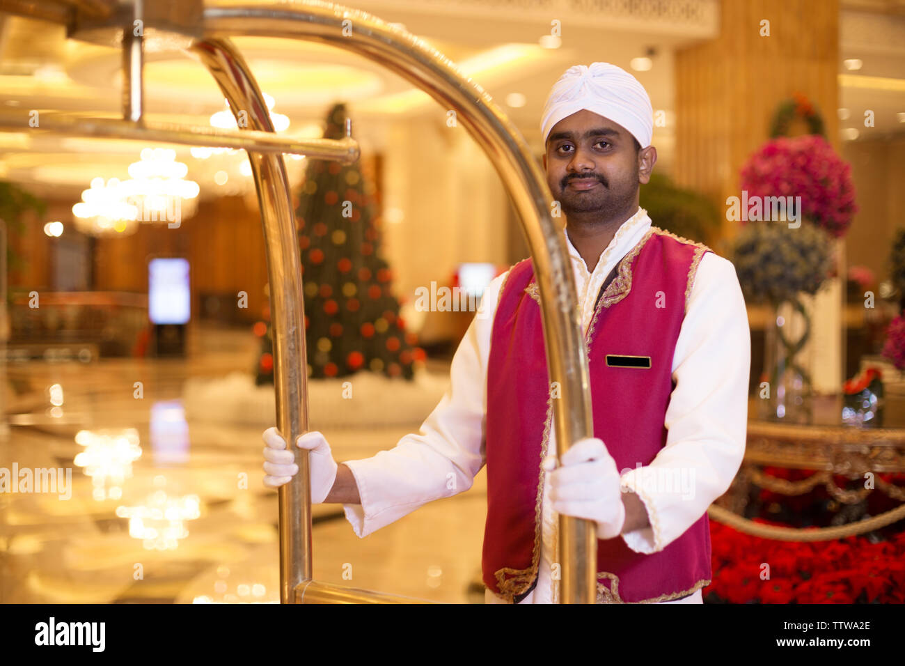 young indian porter service in luxury hotel lobby Stock Photo - Alamy