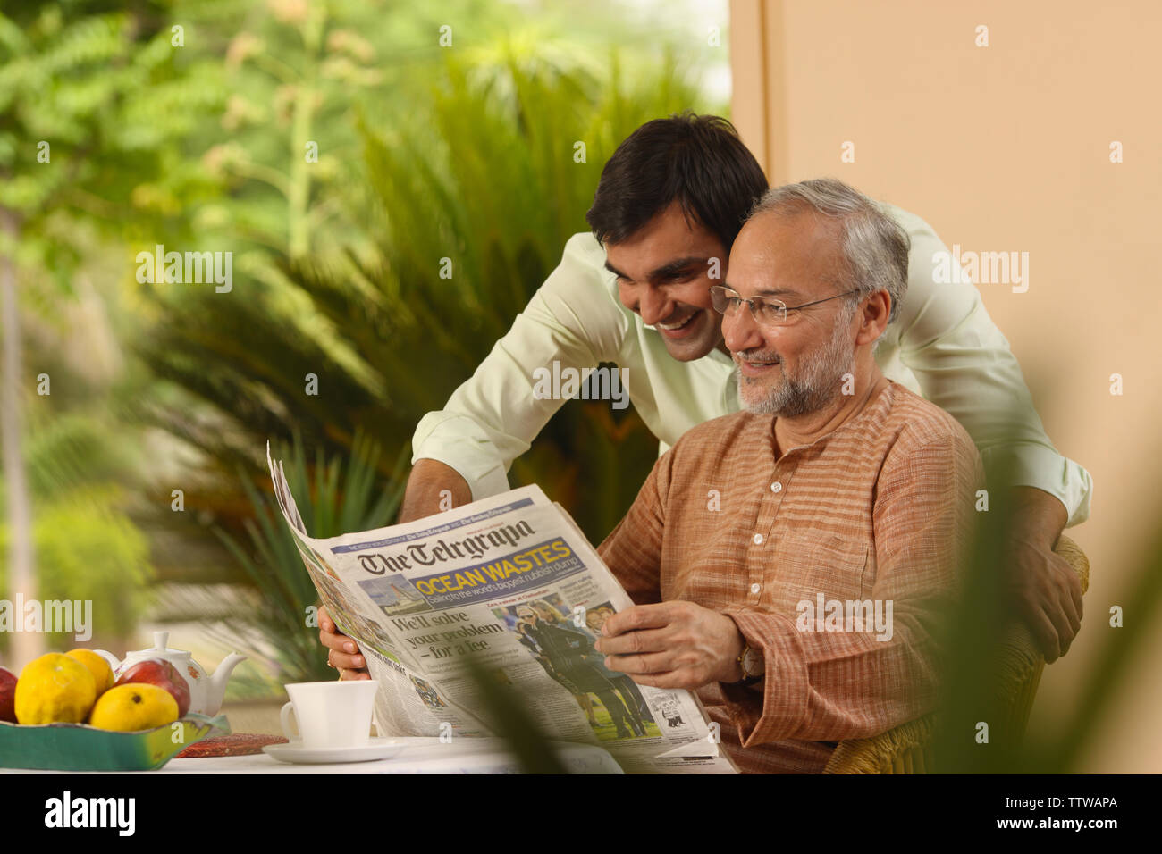 Father and son reading newspaper india hi-res stock photography and ...