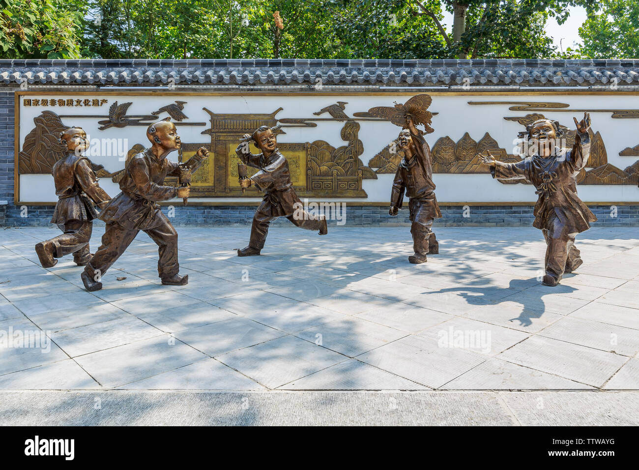 Sculpture of children flying kite scene Stock Photo - Alamy