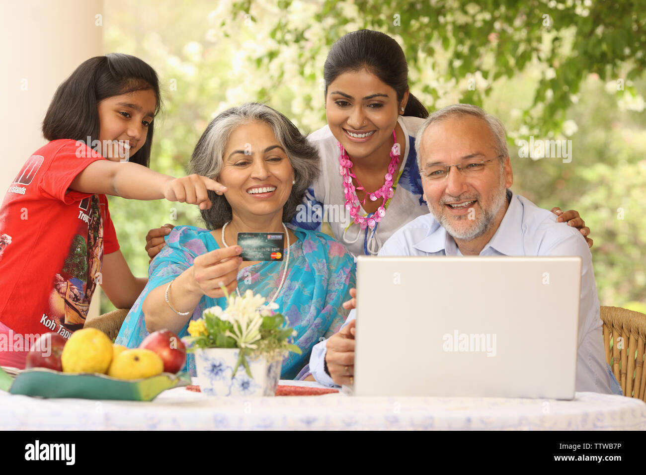 Family looking at a laptop Stock Photo - Alamy