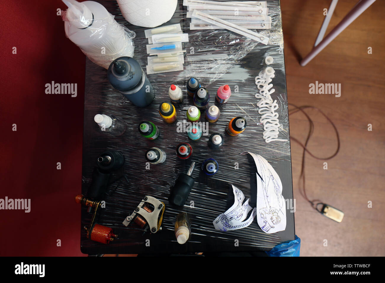 Tattoo master workplace with colorful inks and instruments, close up ...