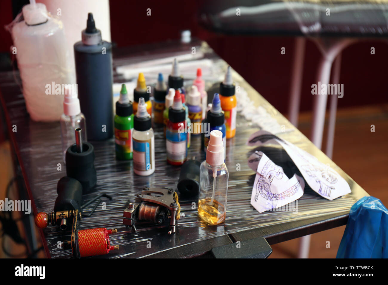 Tattoo master workplace with colorful inks and instruments, close up ...