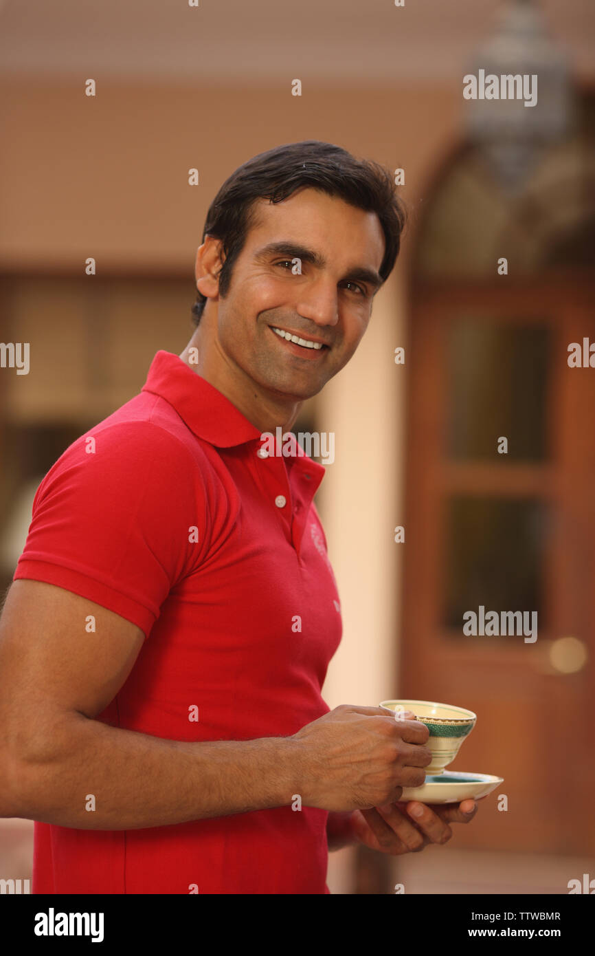 Portrait of an Indian man having tea Stock Photo - Alamy