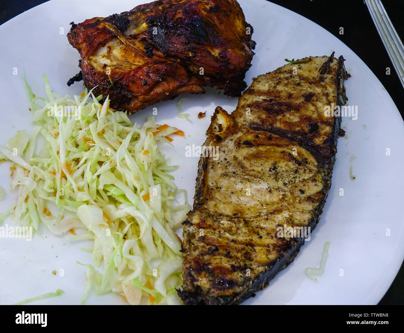Grilled fish on white dish for lunch in Mauritius Island Stock Photo ...