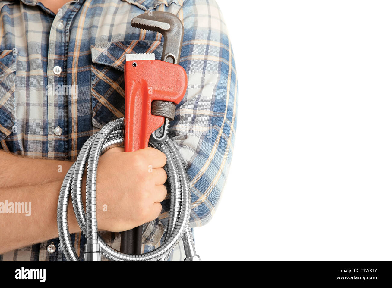 Man with pipe wrench and flexible hose isolated on white, close up view ...