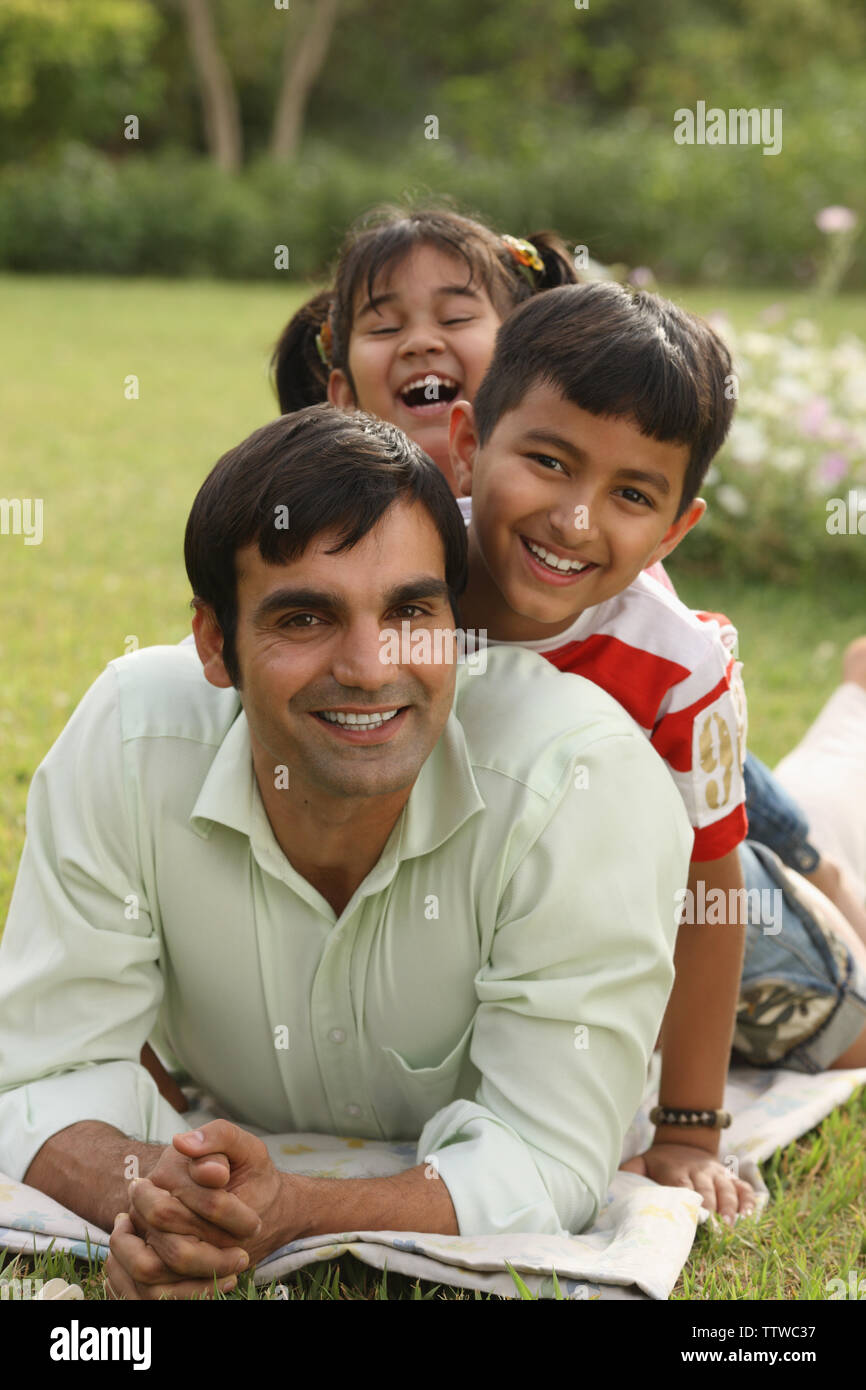 Family in lawn on top of each other Stock Photo - Alamy