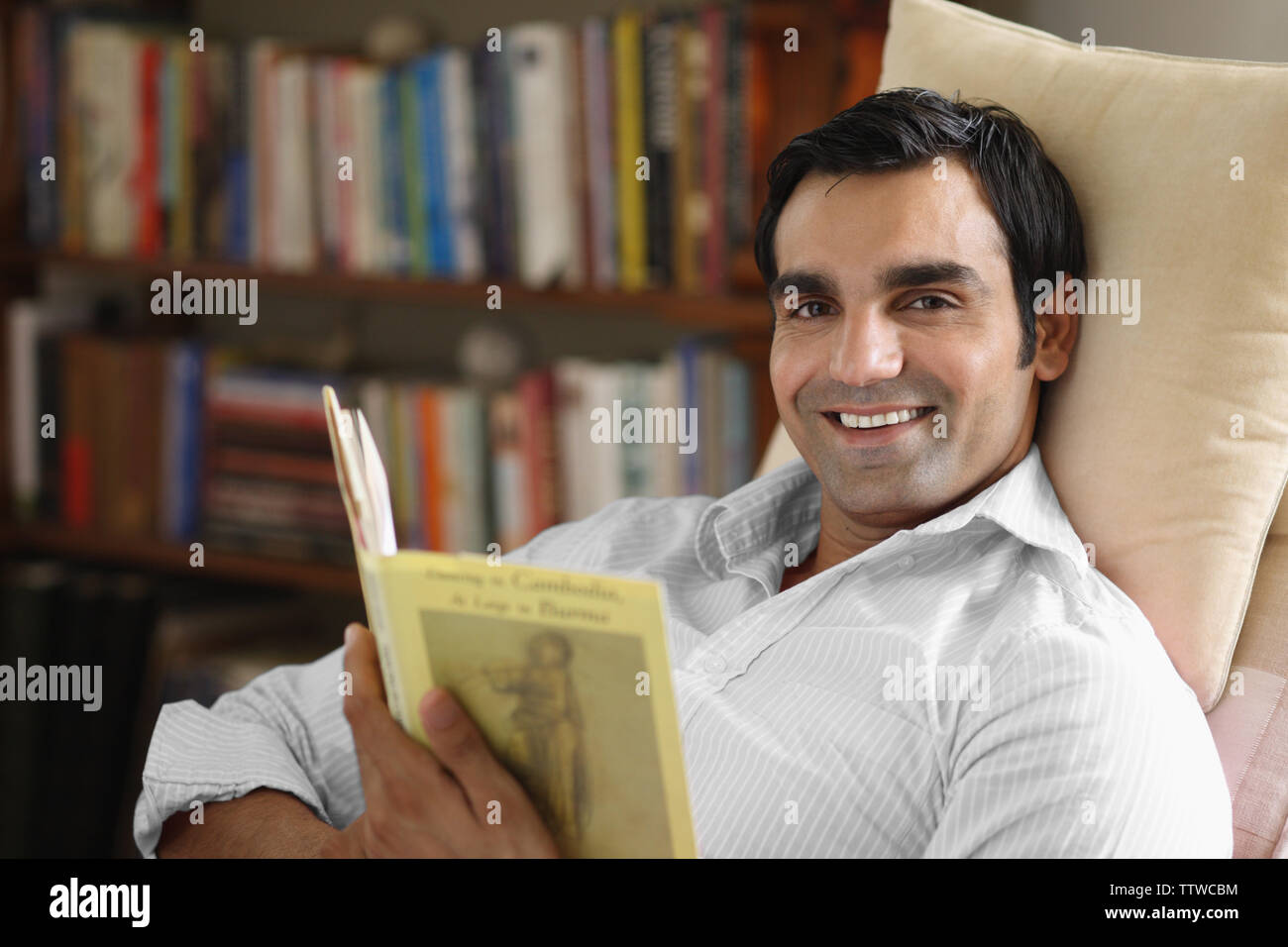 Indian man book reading reclining hi-res stock photography and images ...