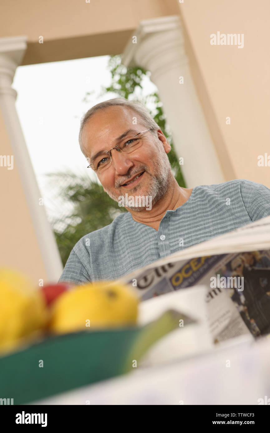 Indian man home newspaper hi-res stock photography and images - Alamy