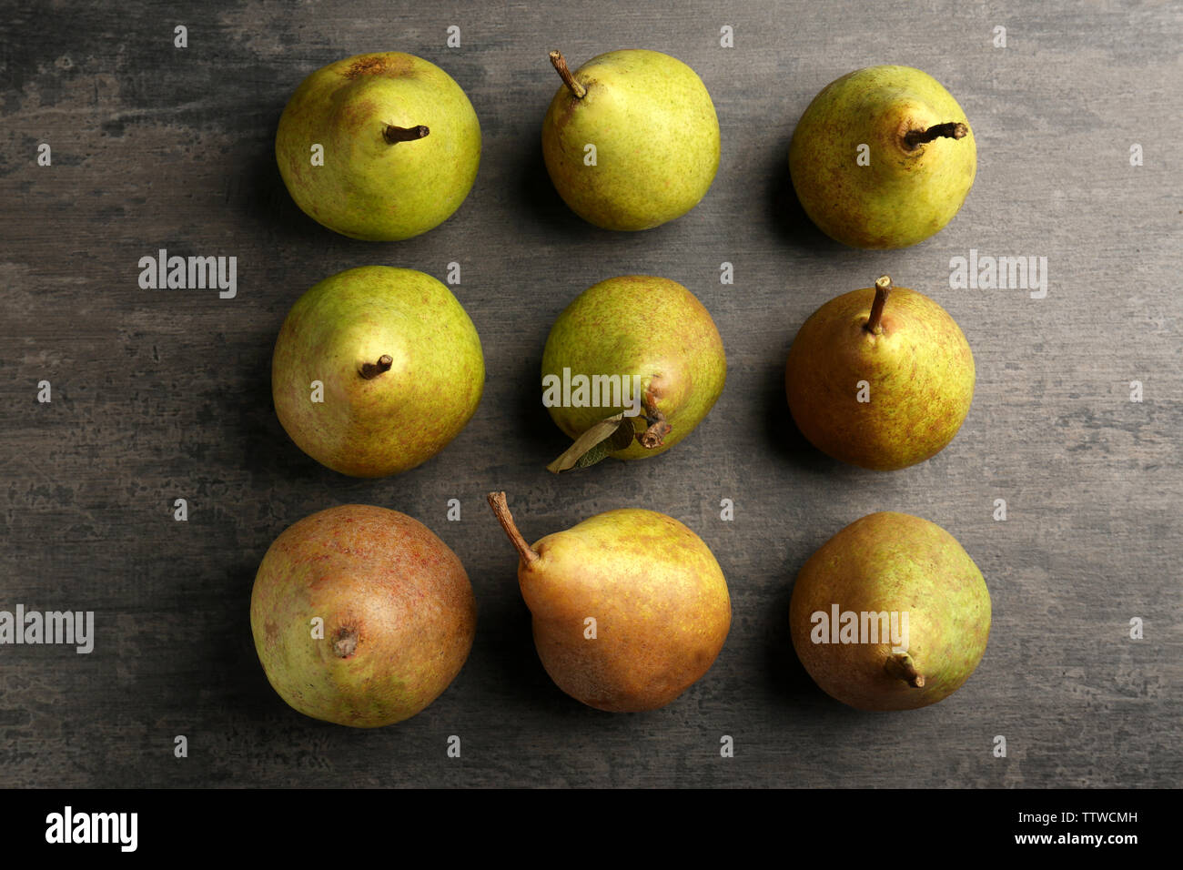 Green pears on grey background Stock Photo - Alamy