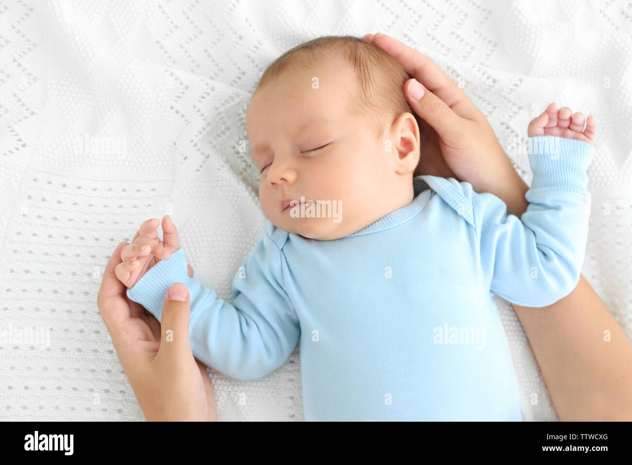 Mother hands touching cute sleeping baby, close up view Stock Photo - Alamy