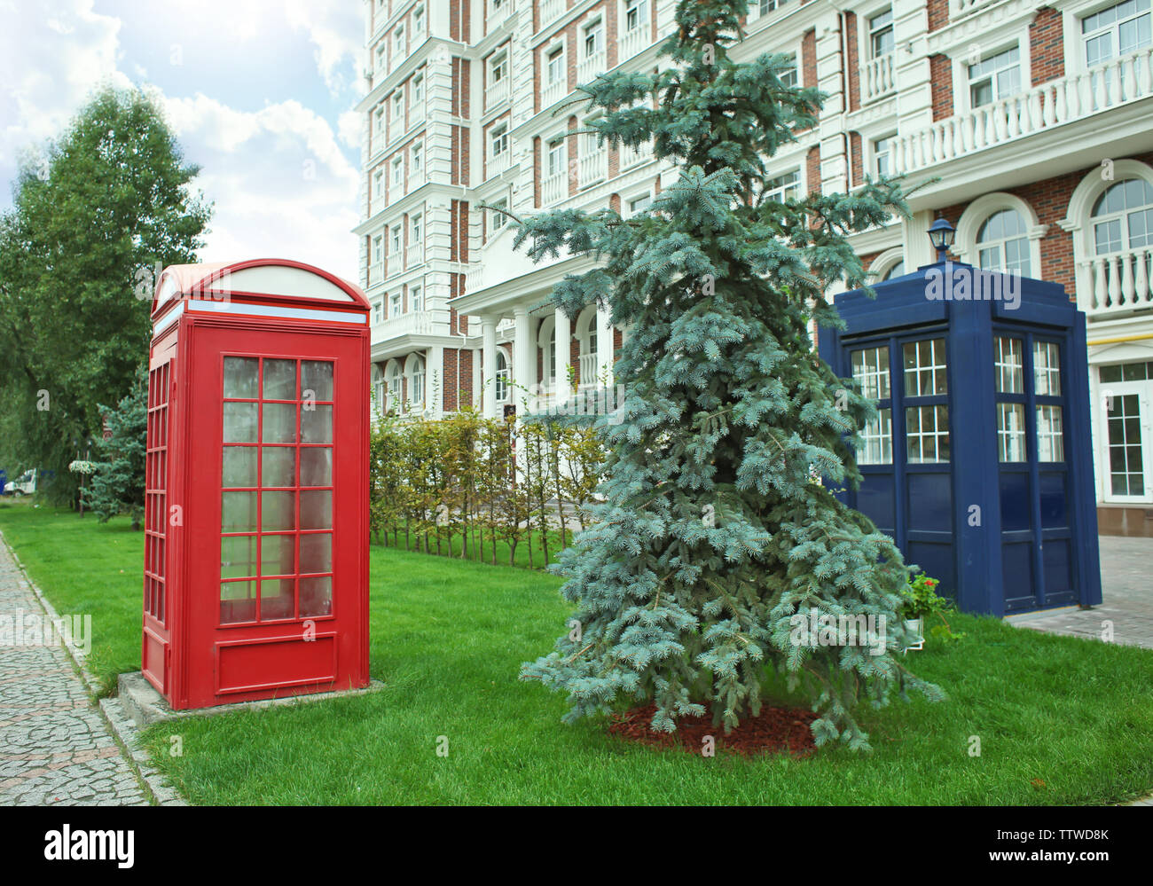 Red Telephone booth on city street Stock Photo - Alamy